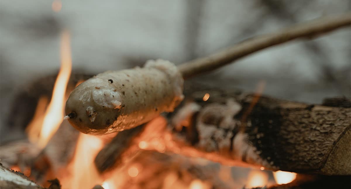 Cooking a Hot Dog On a Stick Over a Fire - 10 Toes Travel
